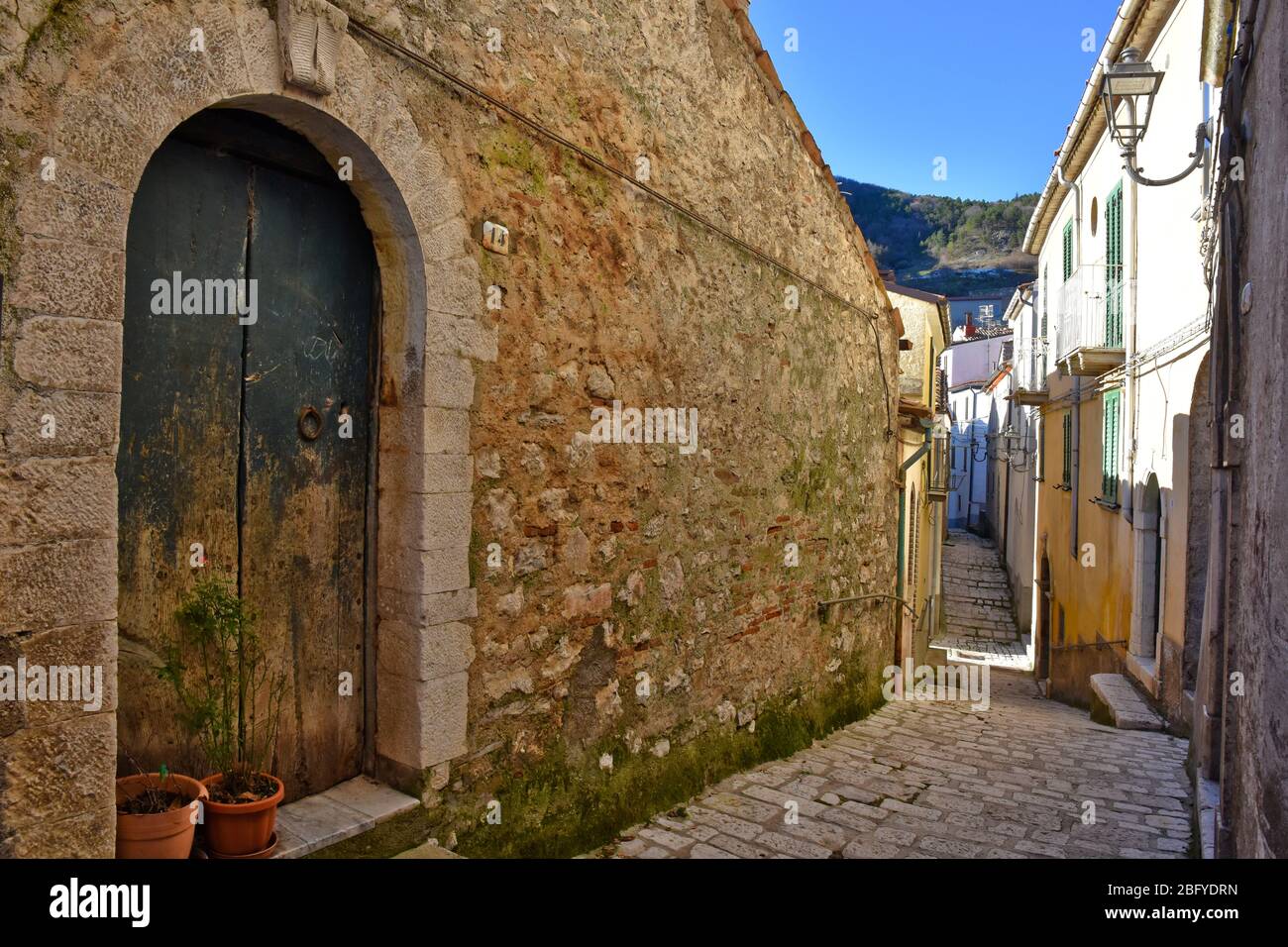 A narrow street between the old houses of Roccamandolfi in the Molise ...