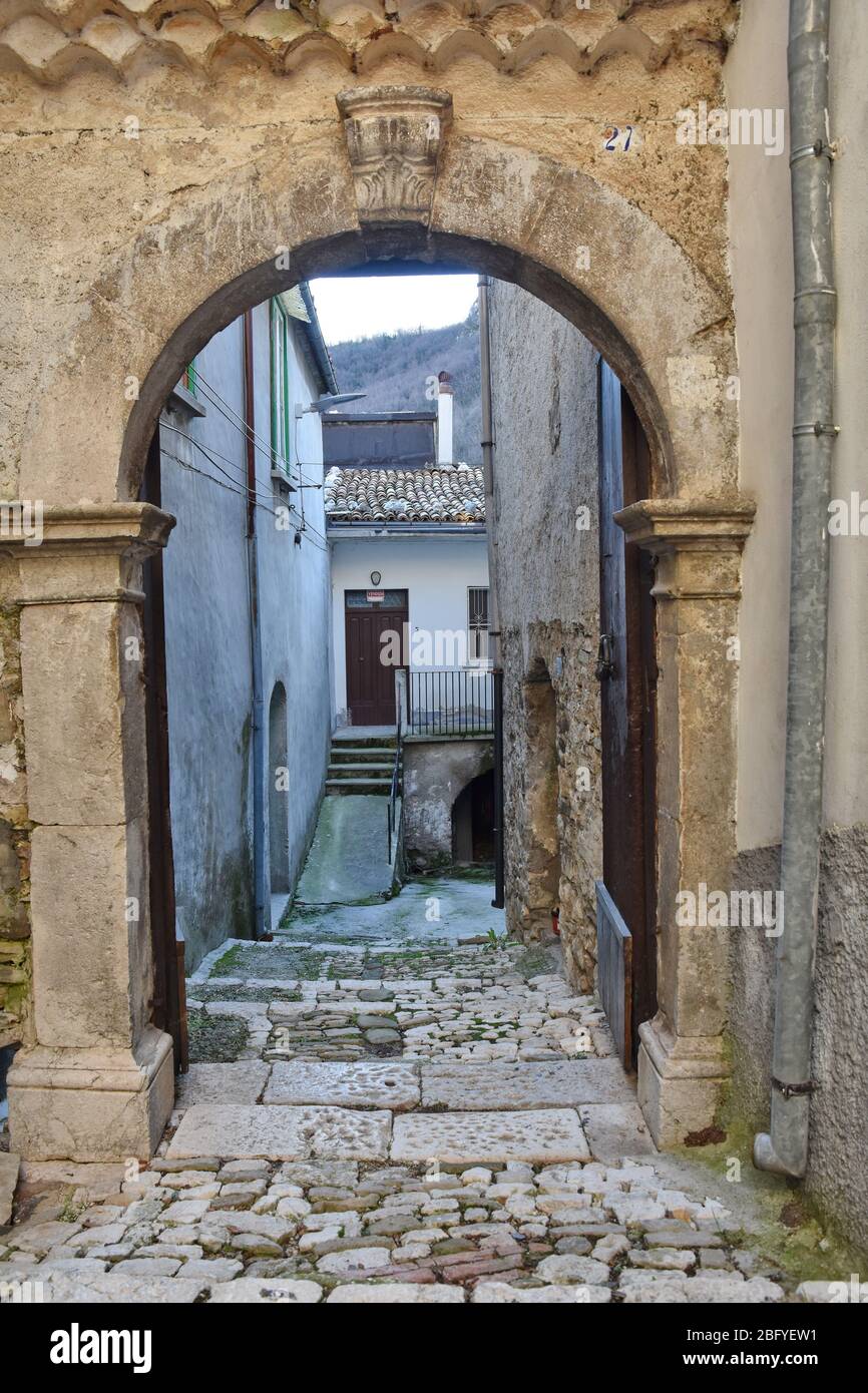 A narrow street between the old houses of Roccamandolfi in the Molise ...