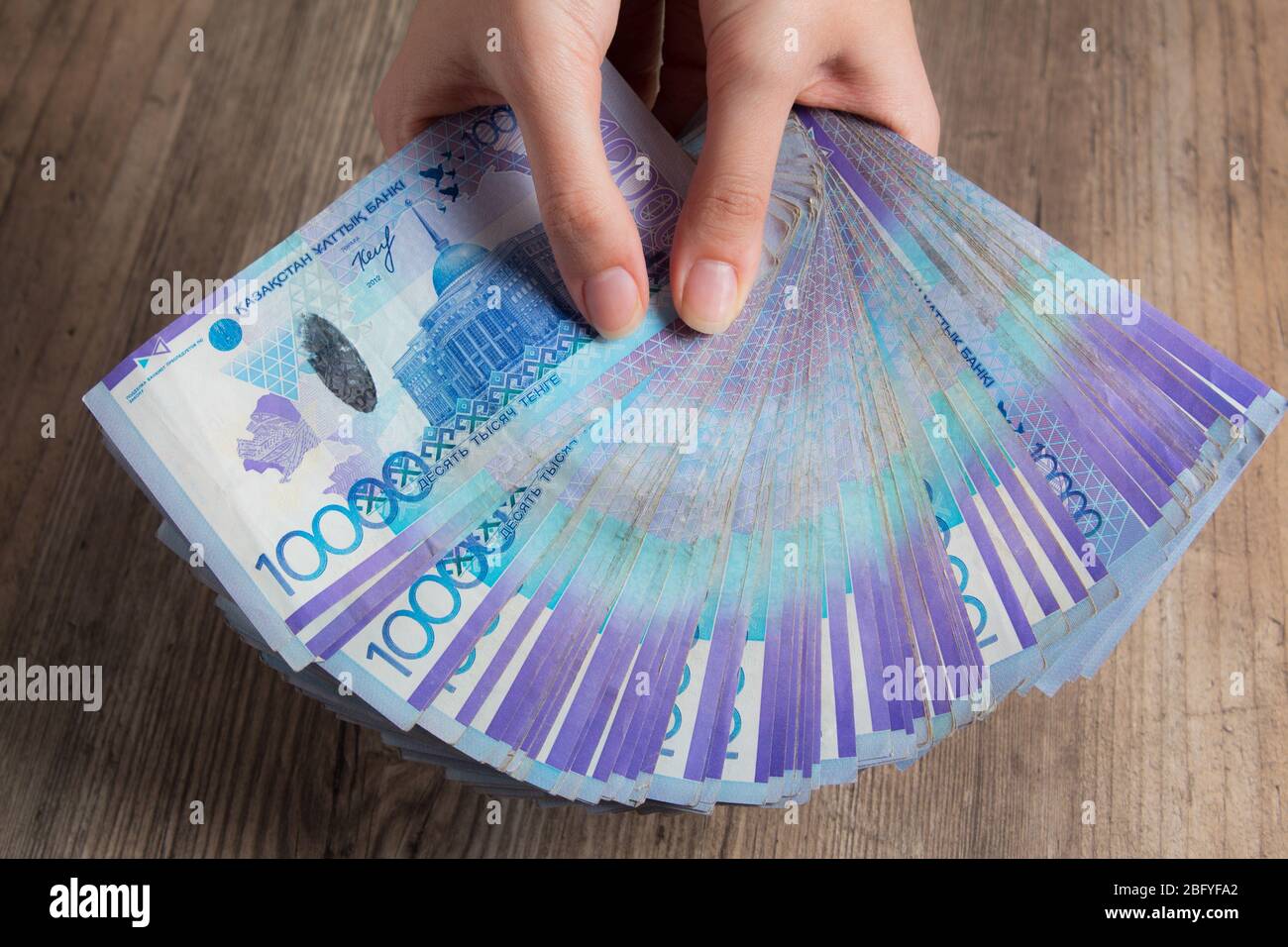 Hands hold a lot of money. Tenge KZT. National currency of Kazakhstan ...
