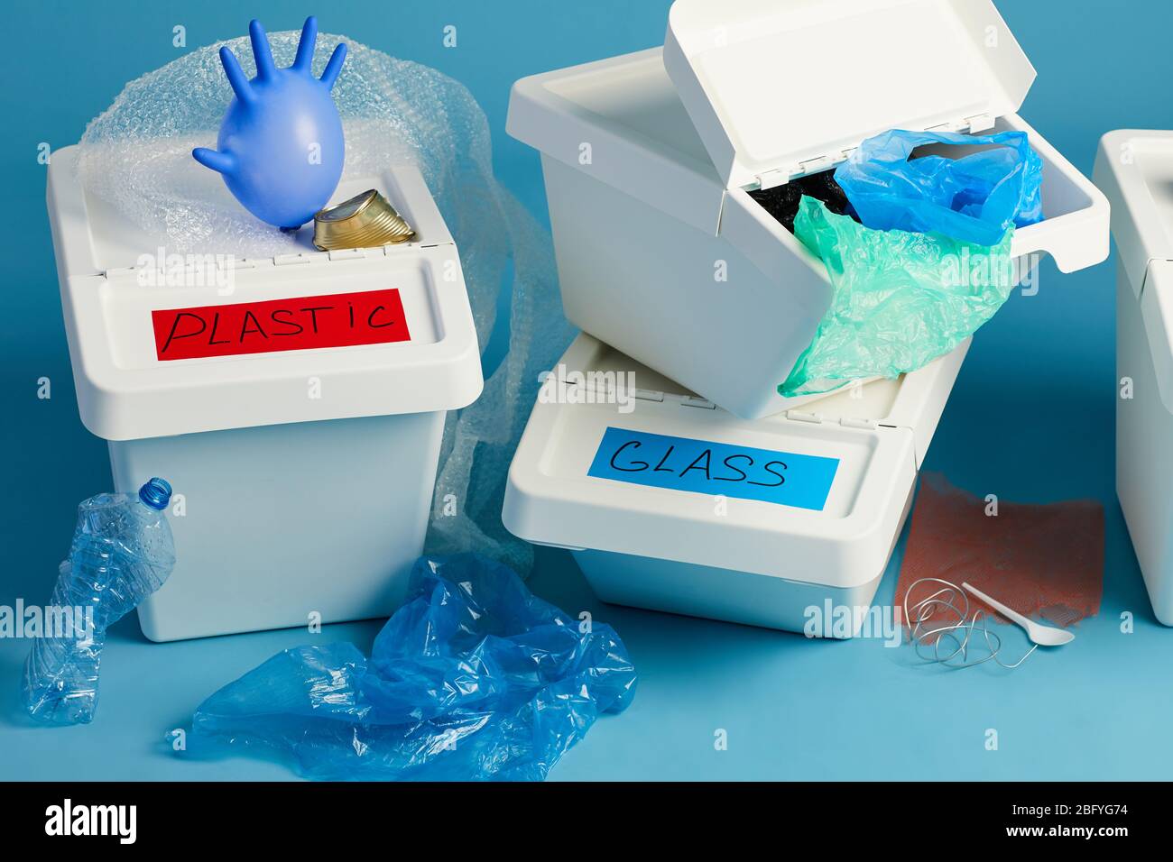 Close up of full trash bins for plastic and paper waste in row against ...