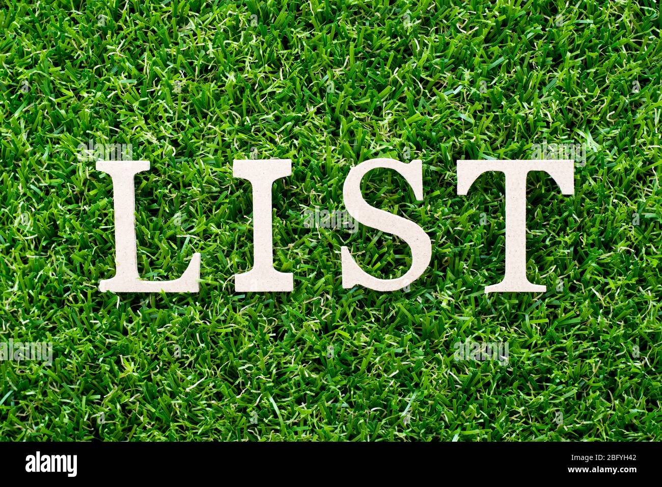 Wood letter in word list on artificial green grass background Stock ...