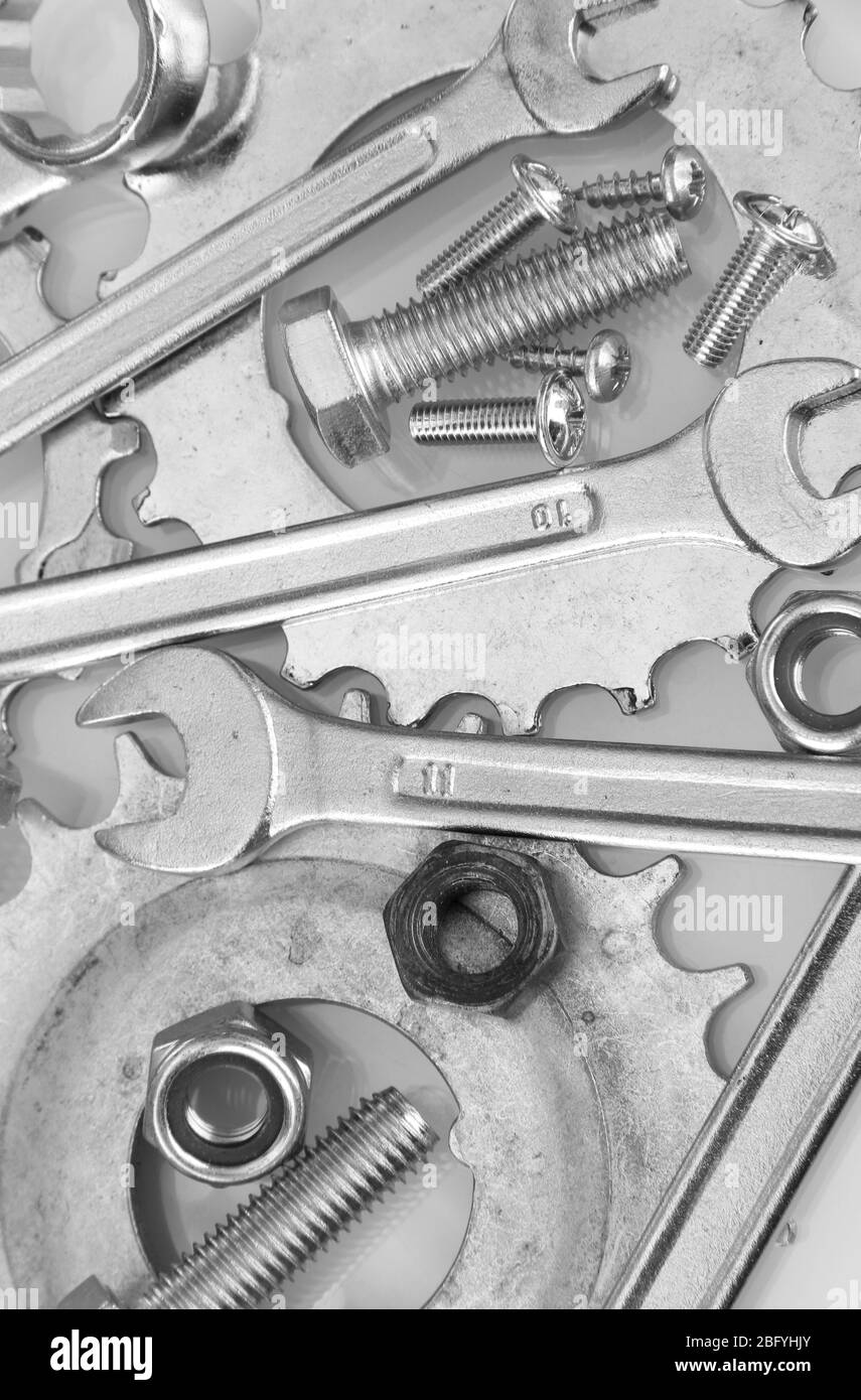 Machine gear, metal cogwheels, nuts and bolts background, close-up ...