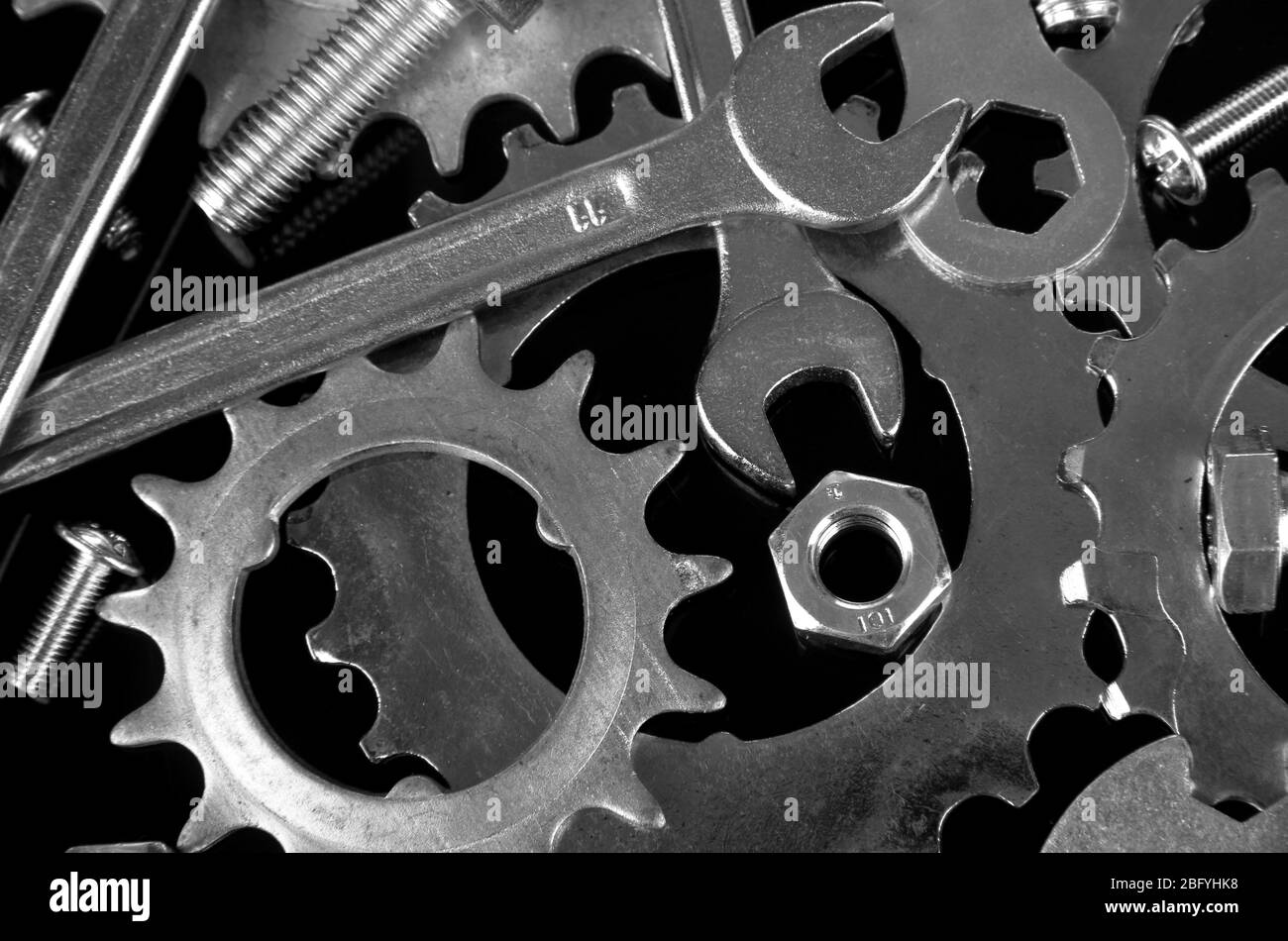 Machine gear, metal cogwheels, nuts and bolts background, close-up ...