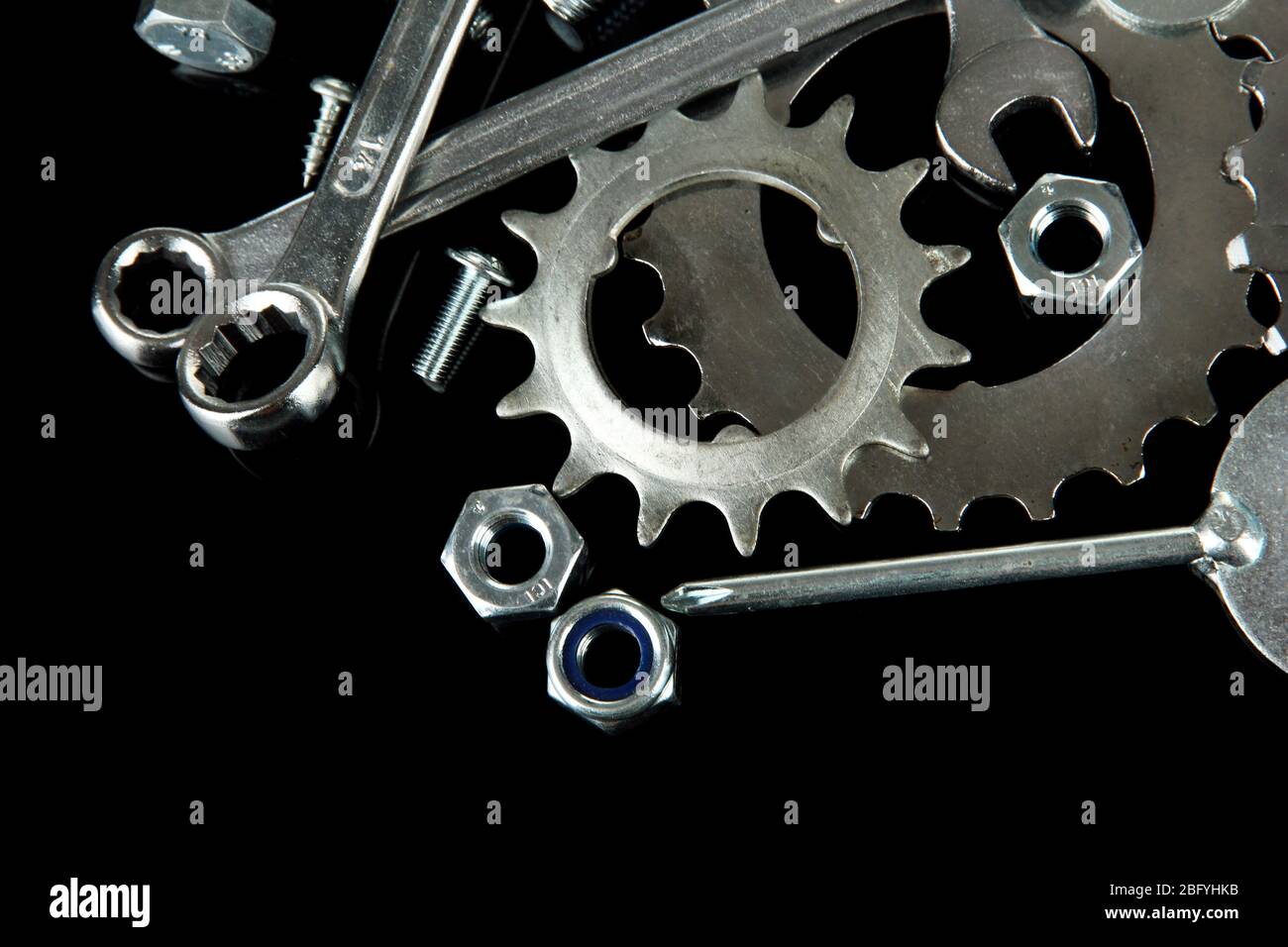 Machine gear, metal cogwheels, nuts and bolts isolated on black Stock ...