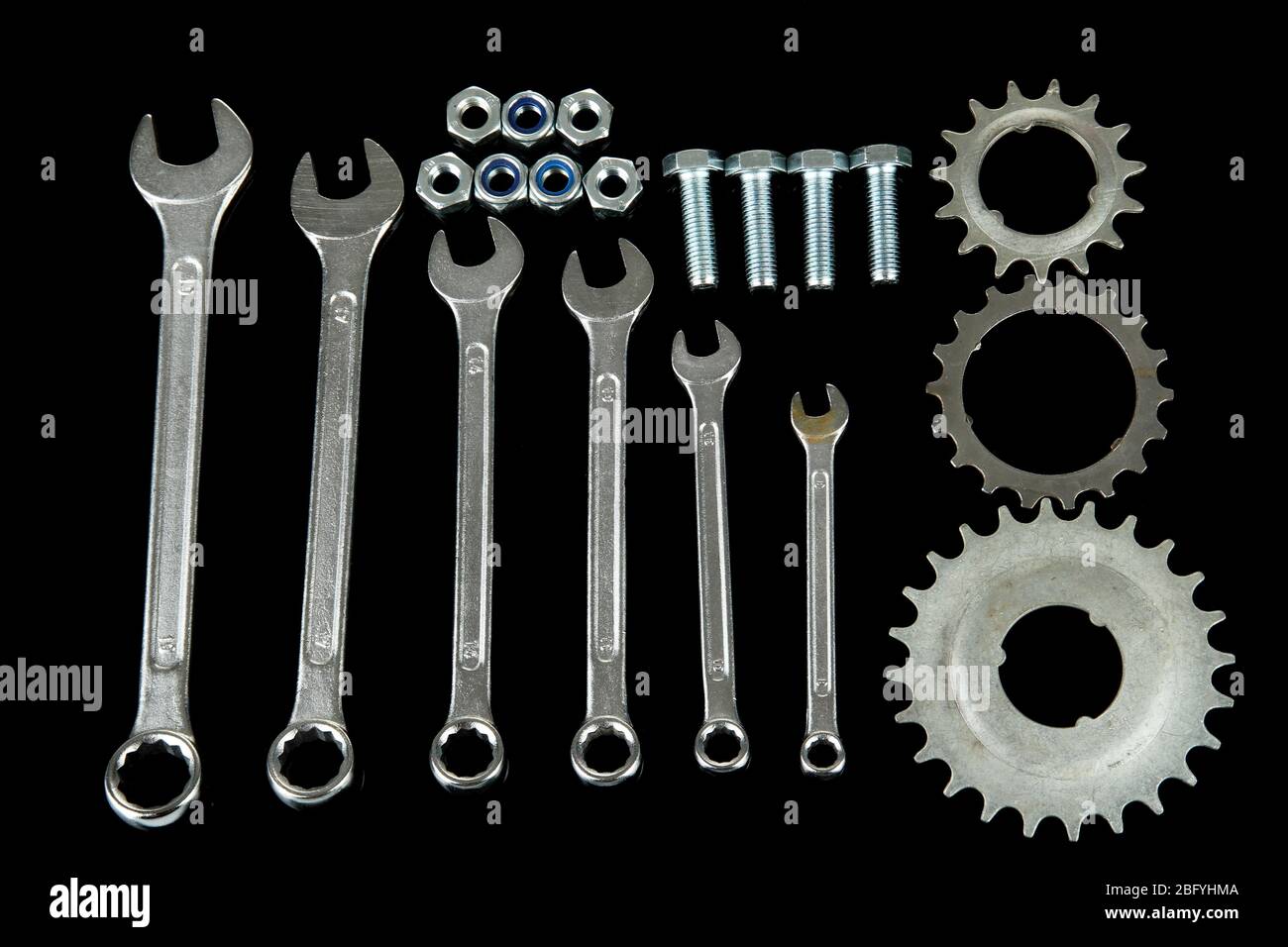 Machine gear, metal cogwheels, nuts and bolts isolated on black Stock ...
