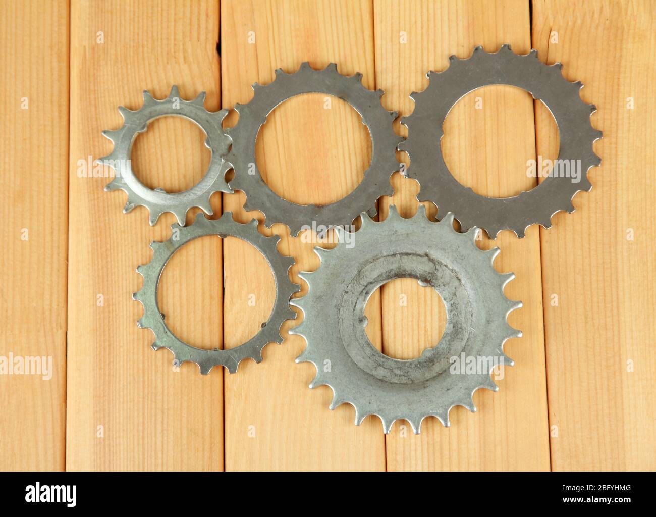 Metal cogwheels on wooden background Stock Photo - Alamy