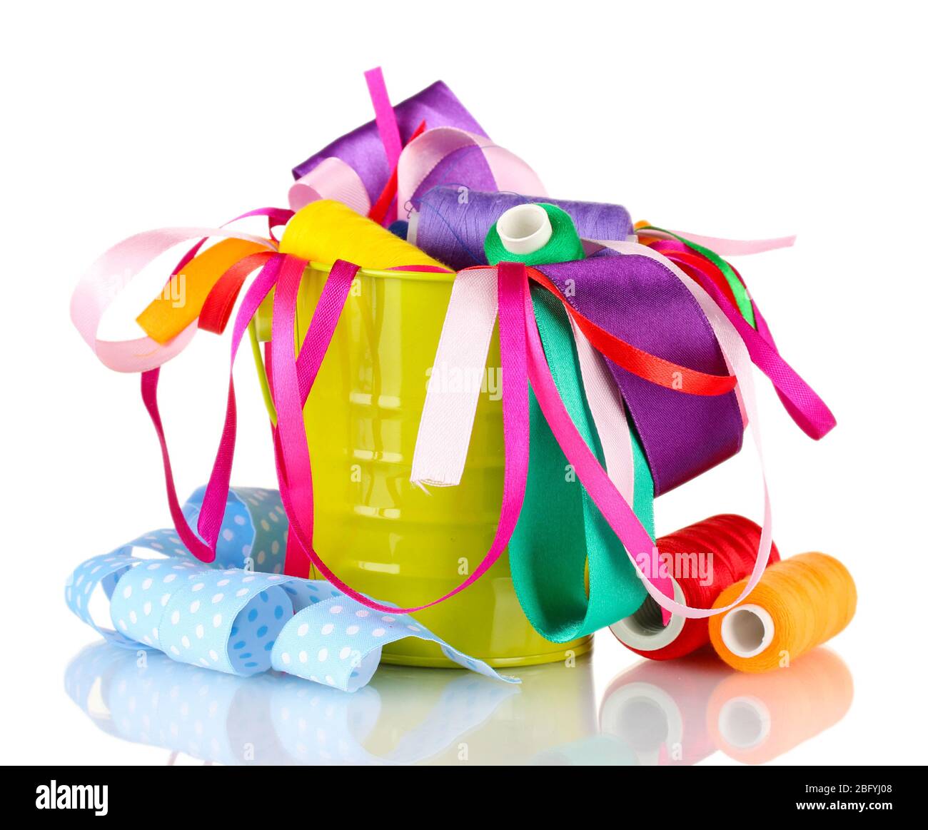 Color bucket with multicolor ribbons and thread isolated on white Stock ...