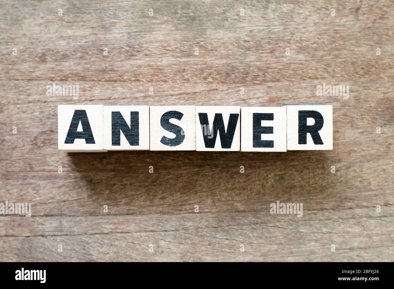 Letter block in word answer on wood background Stock Photo - Alamy