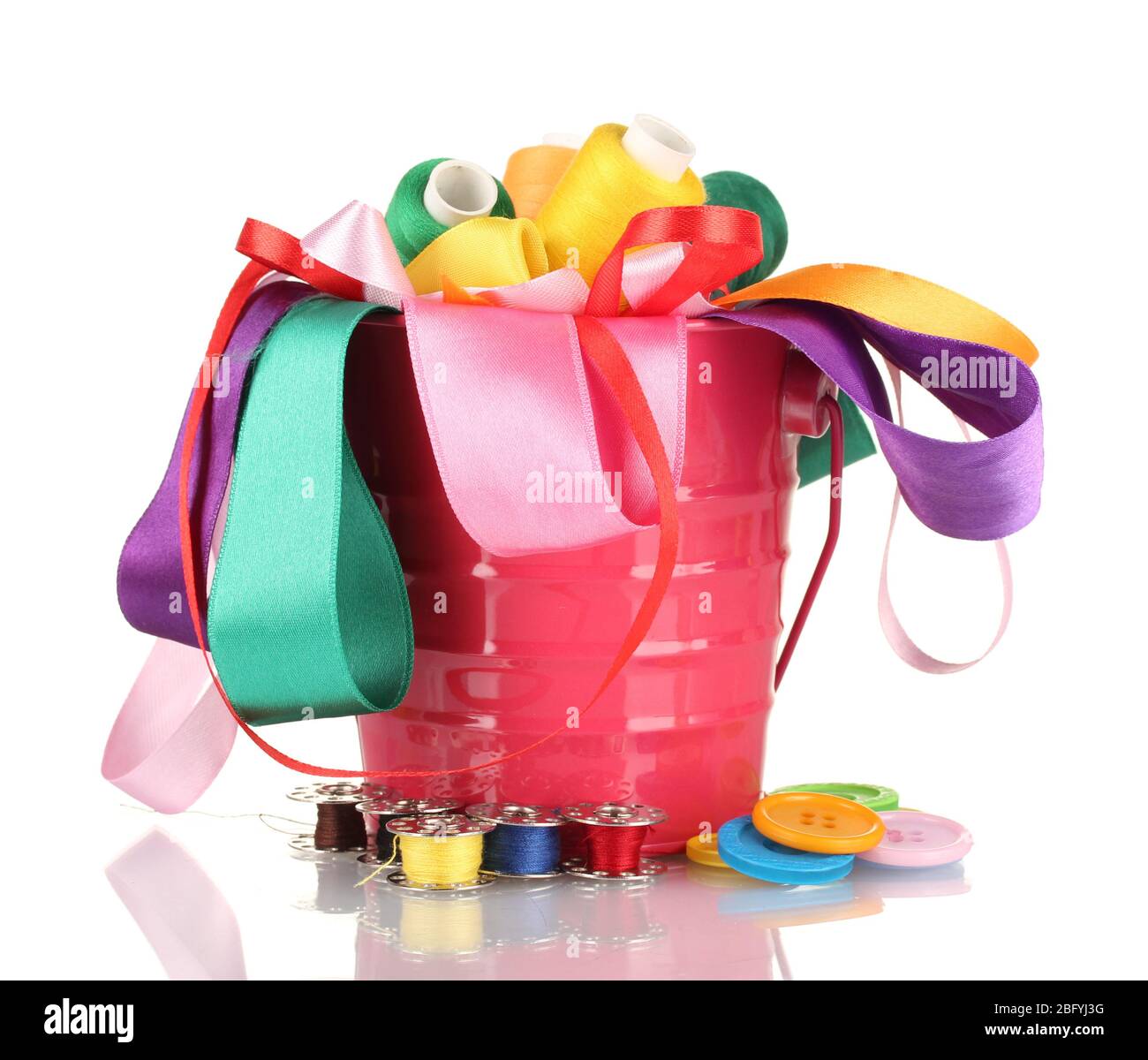 Color bucket with multicolor ribbons and thread isolated on white Stock ...