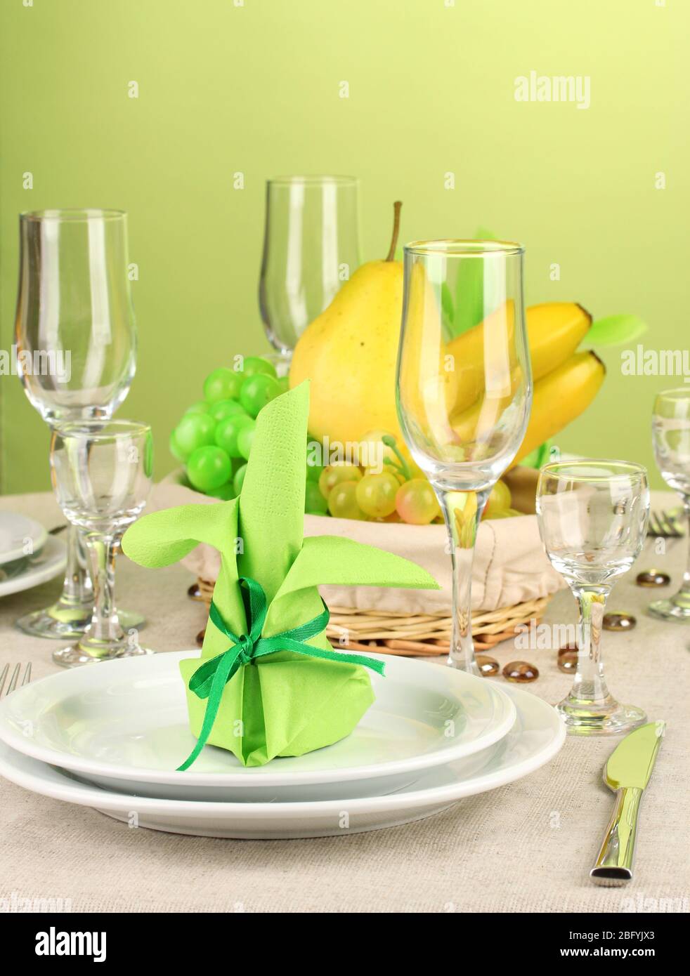 Table setting in green and yellow tones on color background Stock Photo ...