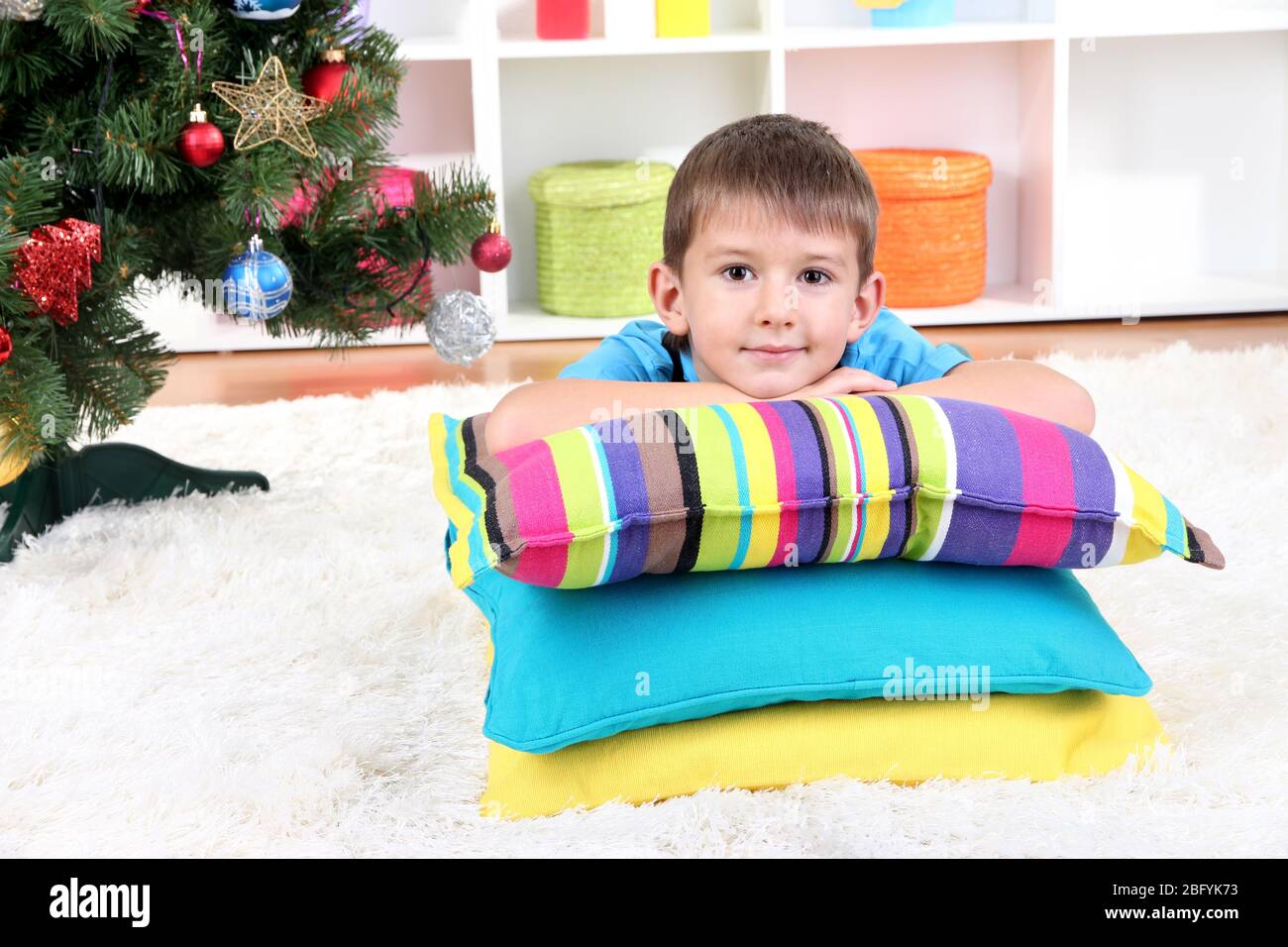 Little boy sleeping under Christmas Tree waiting for Santa Claus to ...