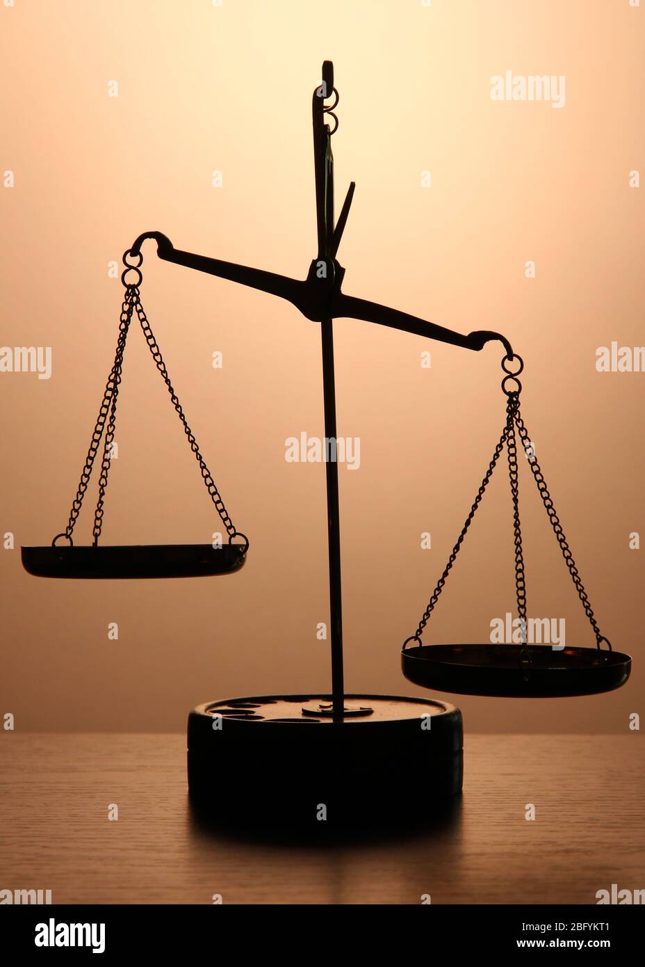 Gold scales of justice on brown background Stock Photo - Alamy