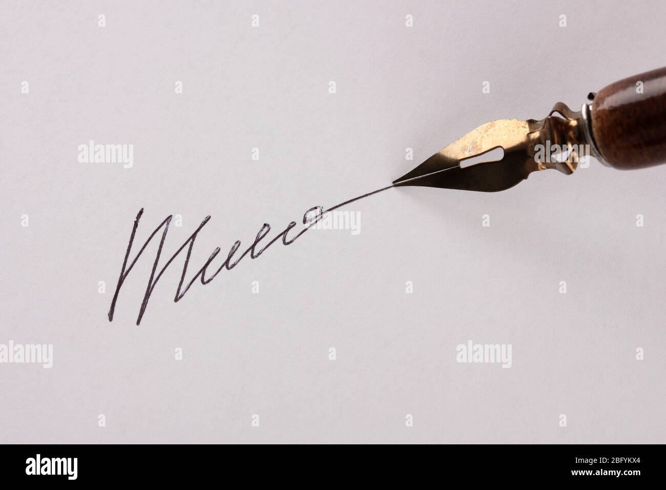 Closeup of signature (fake, not real) and ink pen, isolated on white ...