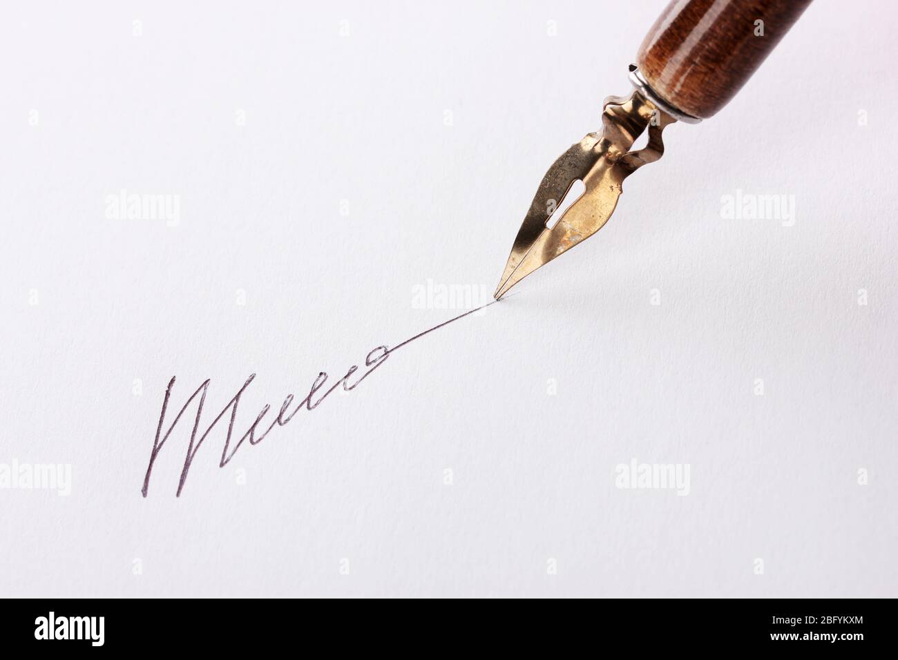 Closeup of signature (fake, not real) and ink pen, isolated on white ...