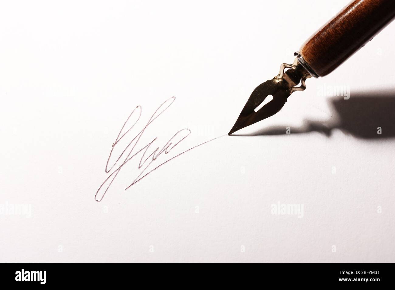 Closeup of signature (fake, not real) and ink pen, isolated on white ...