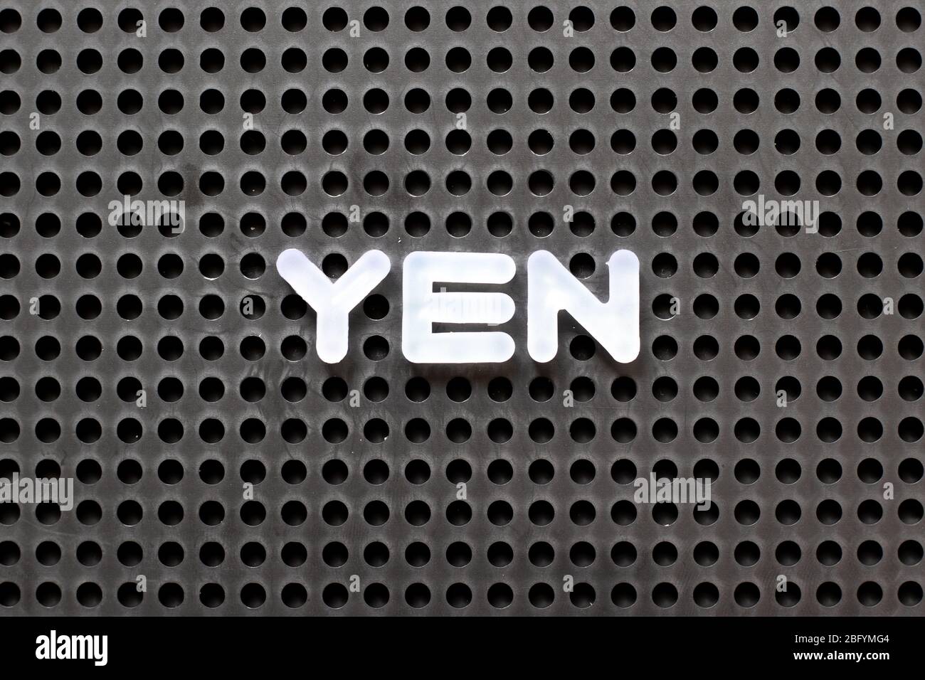 Black color pegboard with white letter in word yen (Concept for ...