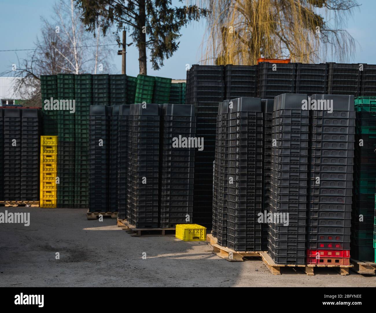 Black plastic boxes in a warehouse outdoor Stock Photo - Alamy
