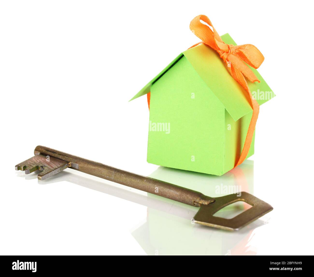 Small house with key isolated on white Stock Photo - Alamy