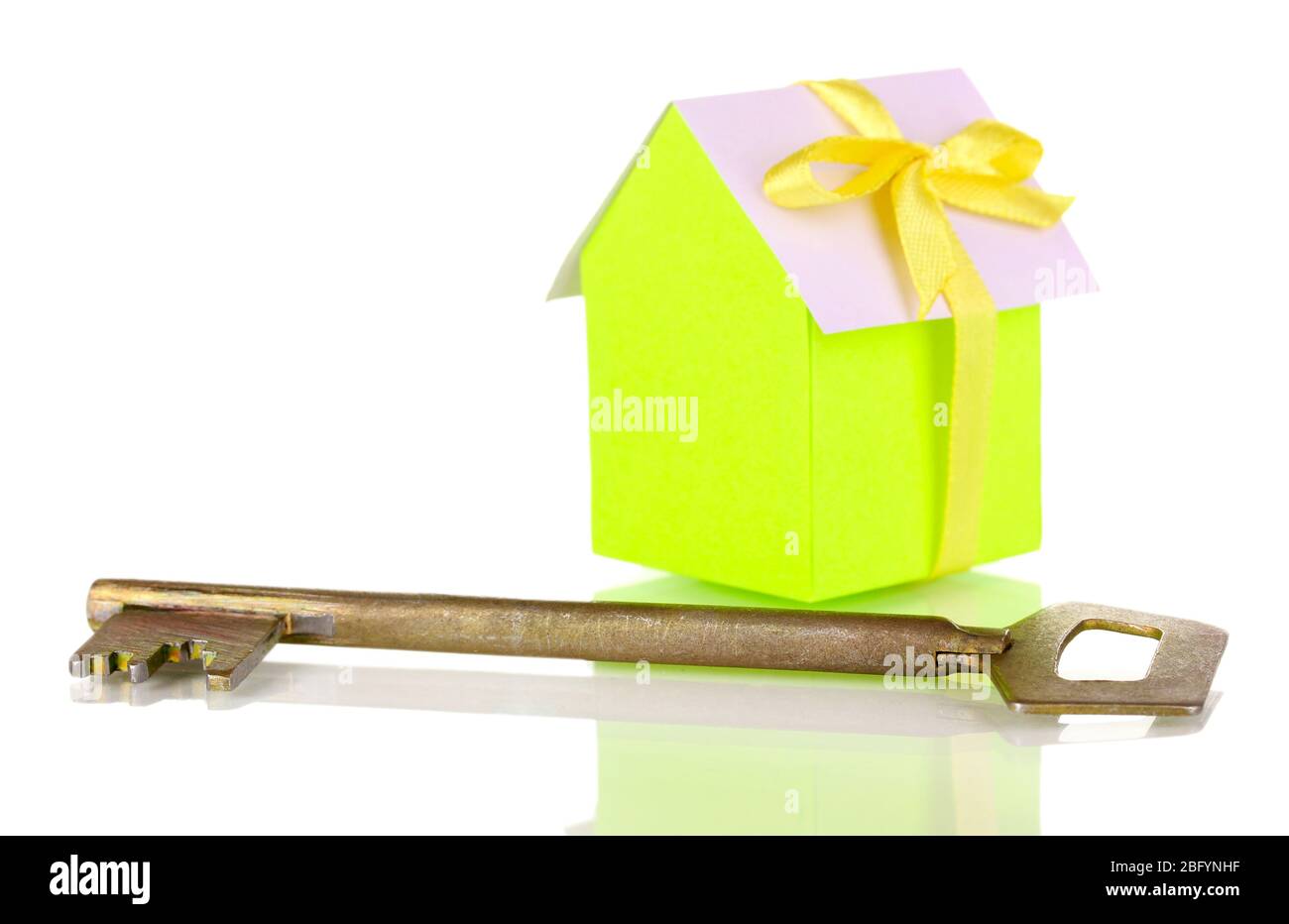 Small house with key isolated on white Stock Photo - Alamy