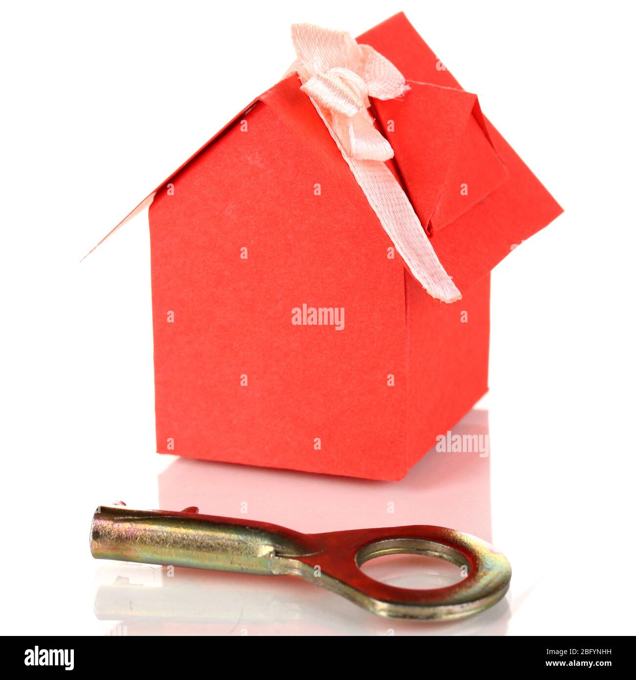 Small house with key isolated on white Stock Photo - Alamy