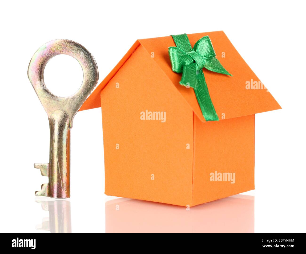 Small house with key isolated on white Stock Photo - Alamy