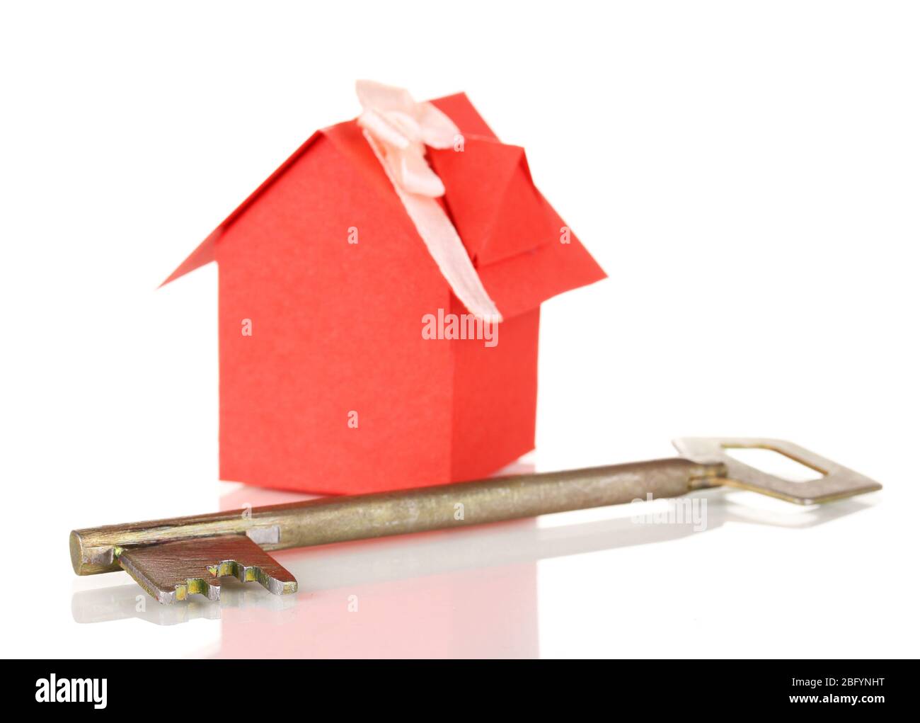 Small house with key isolated on white Stock Photo - Alamy