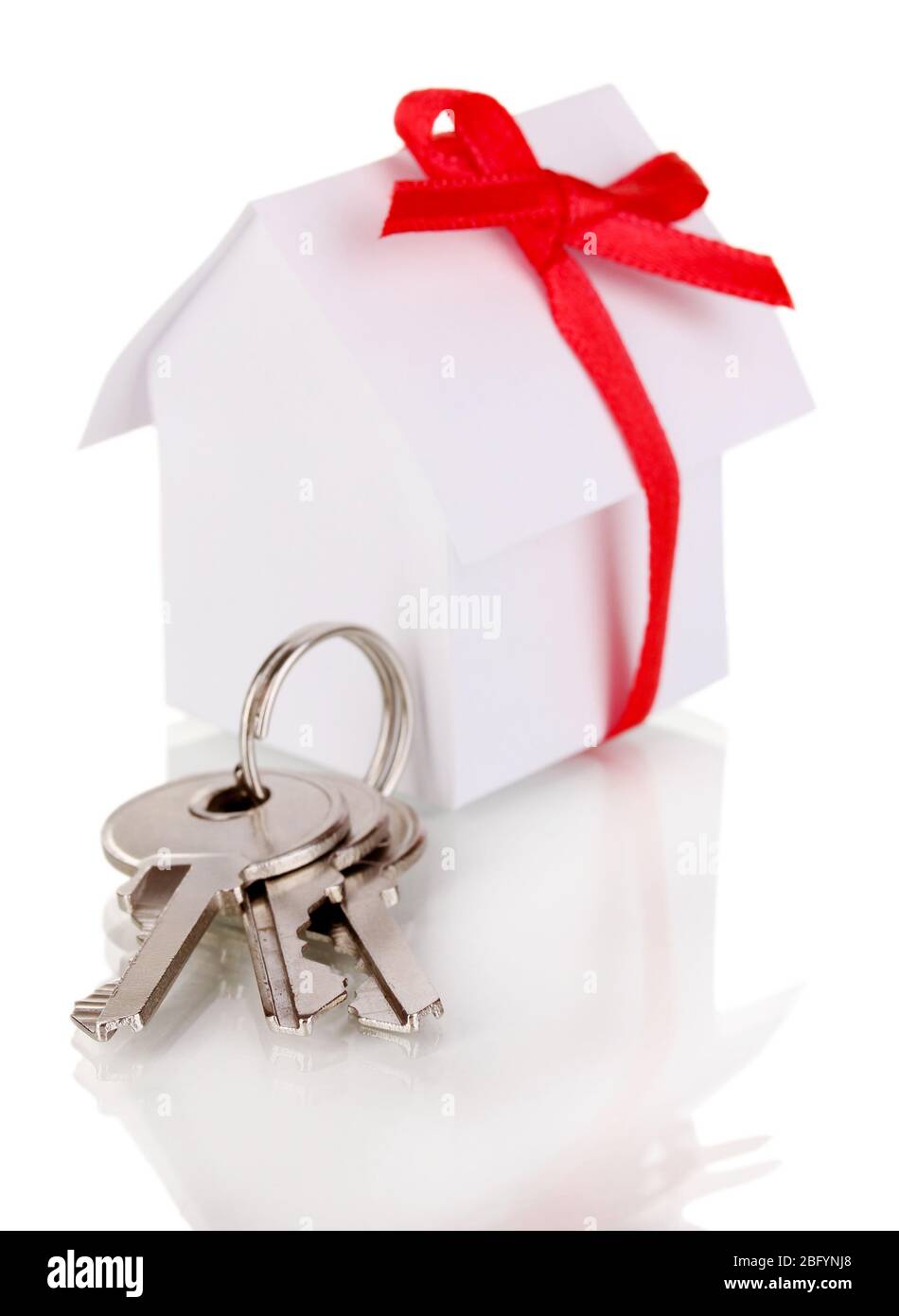 Small house with key isolated on white Stock Photo - Alamy