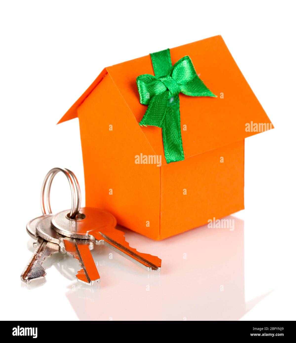 Small house with key isolated on white Stock Photo - Alamy