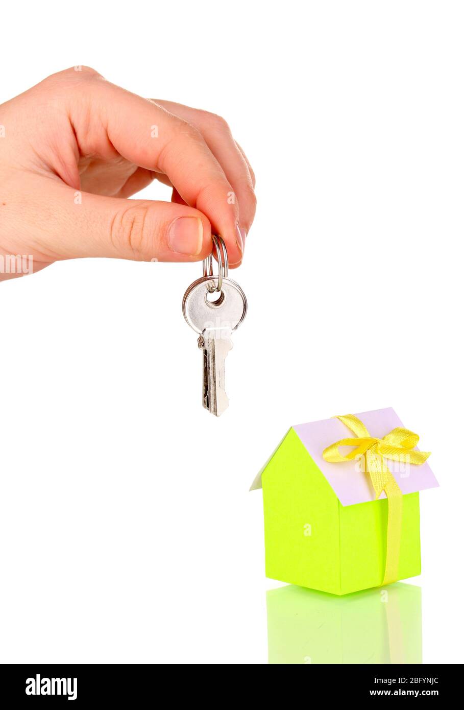 Small house with key isolated on white Stock Photo - Alamy