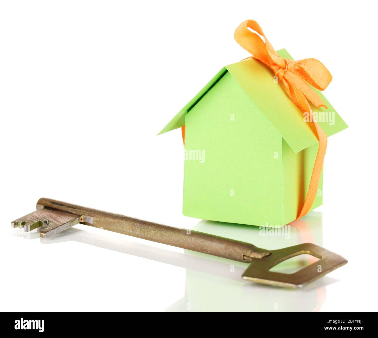 Small house with key isolated on white Stock Photo - Alamy