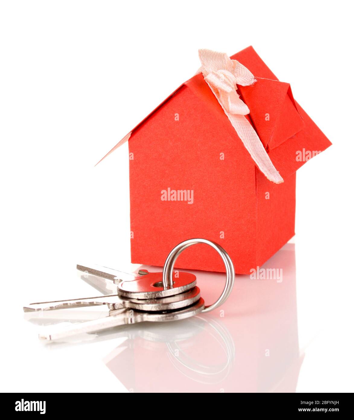 Small house with key isolated on white Stock Photo - Alamy