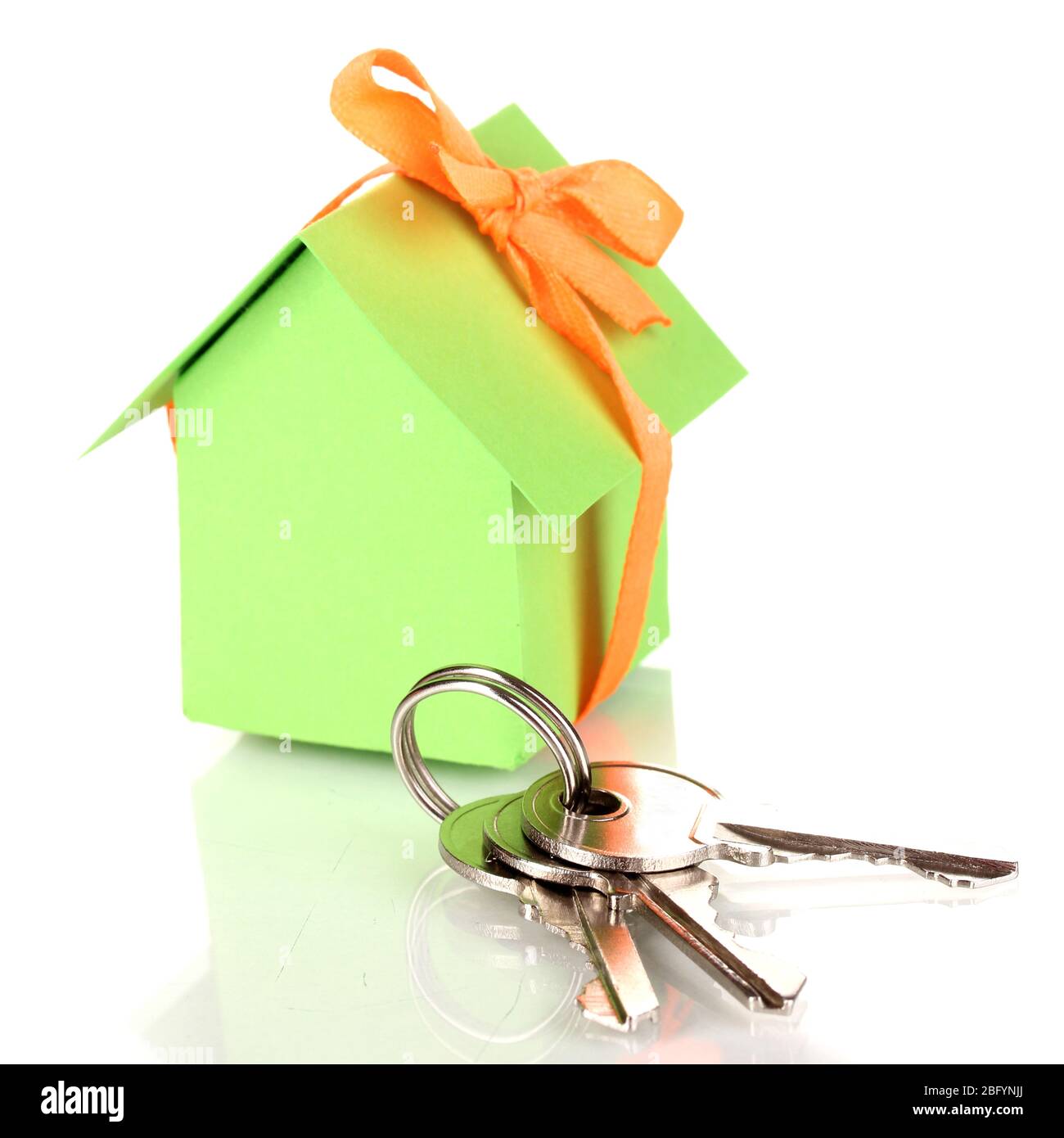 Small house with key isolated on white Stock Photo - Alamy