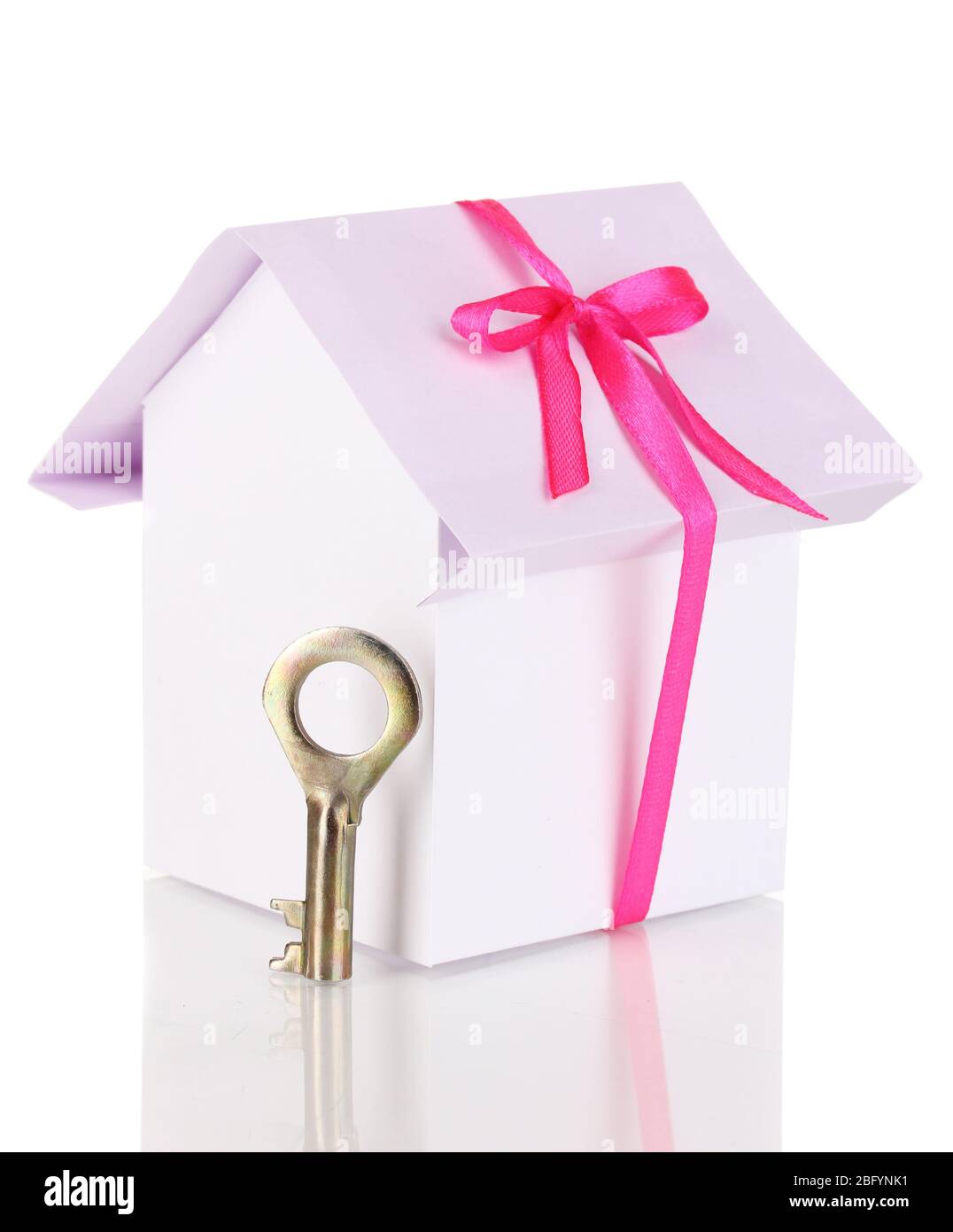 Small house with key isolated on white Stock Photo - Alamy