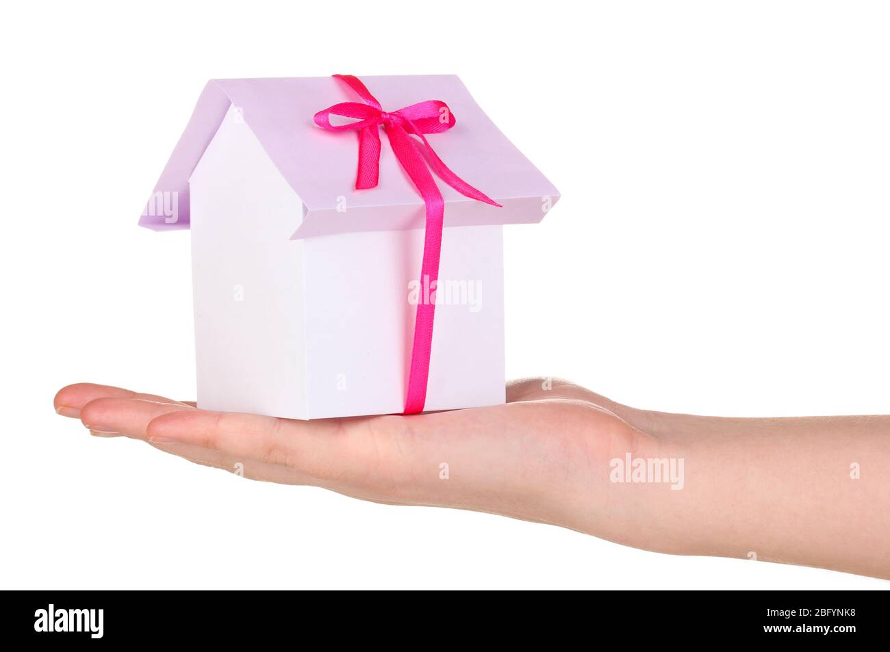 Small house in hand isolated on white Stock Photo - Alamy