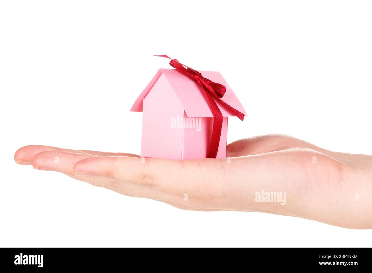 Small house in hand isolated on white Stock Photo - Alamy