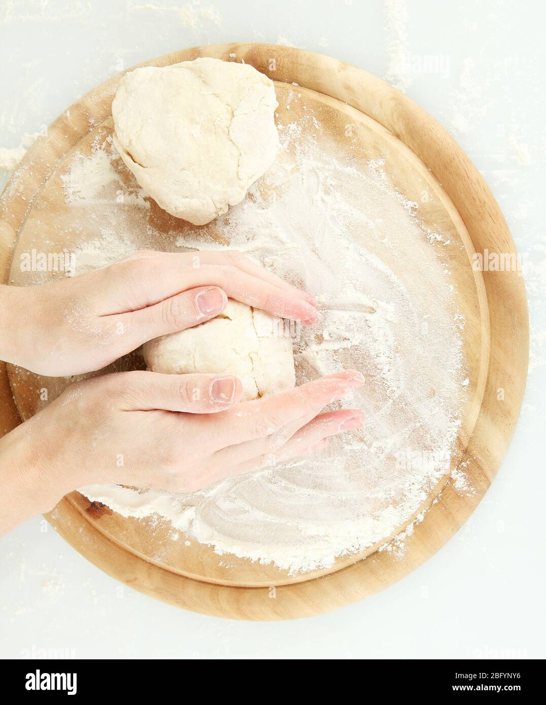 Preparing pizza dough isolated on white Stock Photo - Alamy