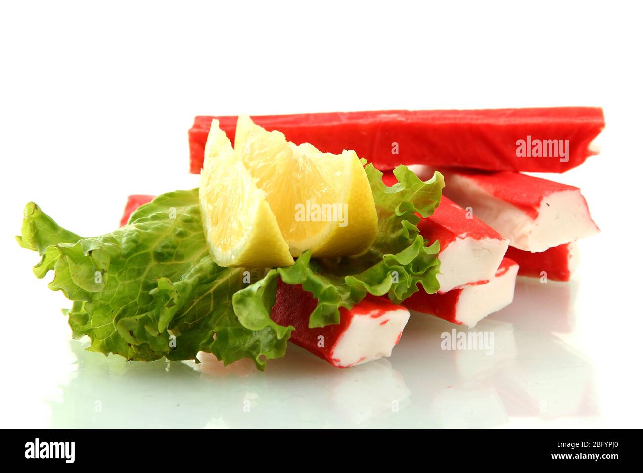 Crab sticks on lettuce leaves with lemon, isolated on white Stock Photo ...