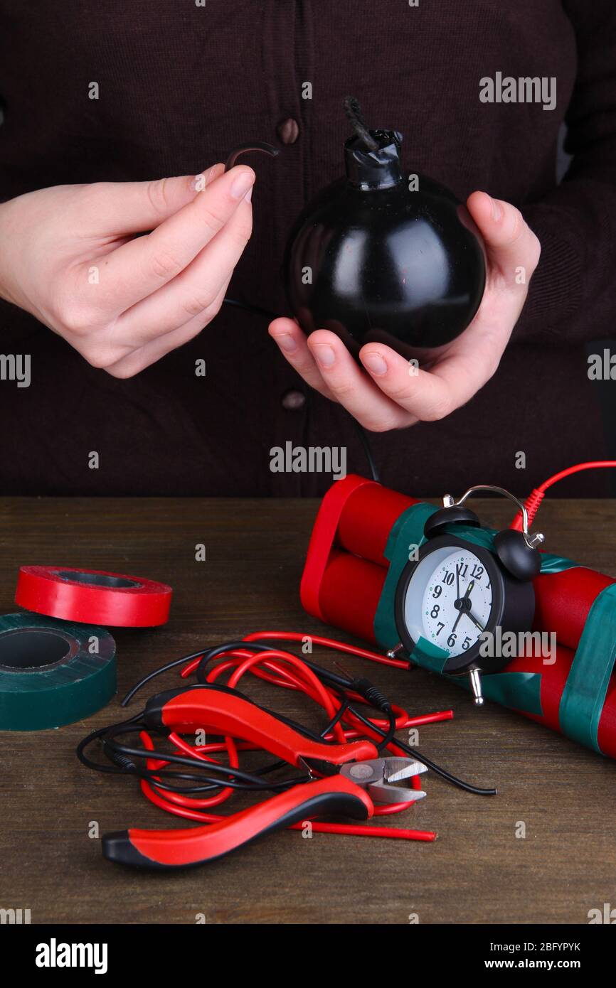 Human makes timebomb on wooden table on black background Stock Photo ...