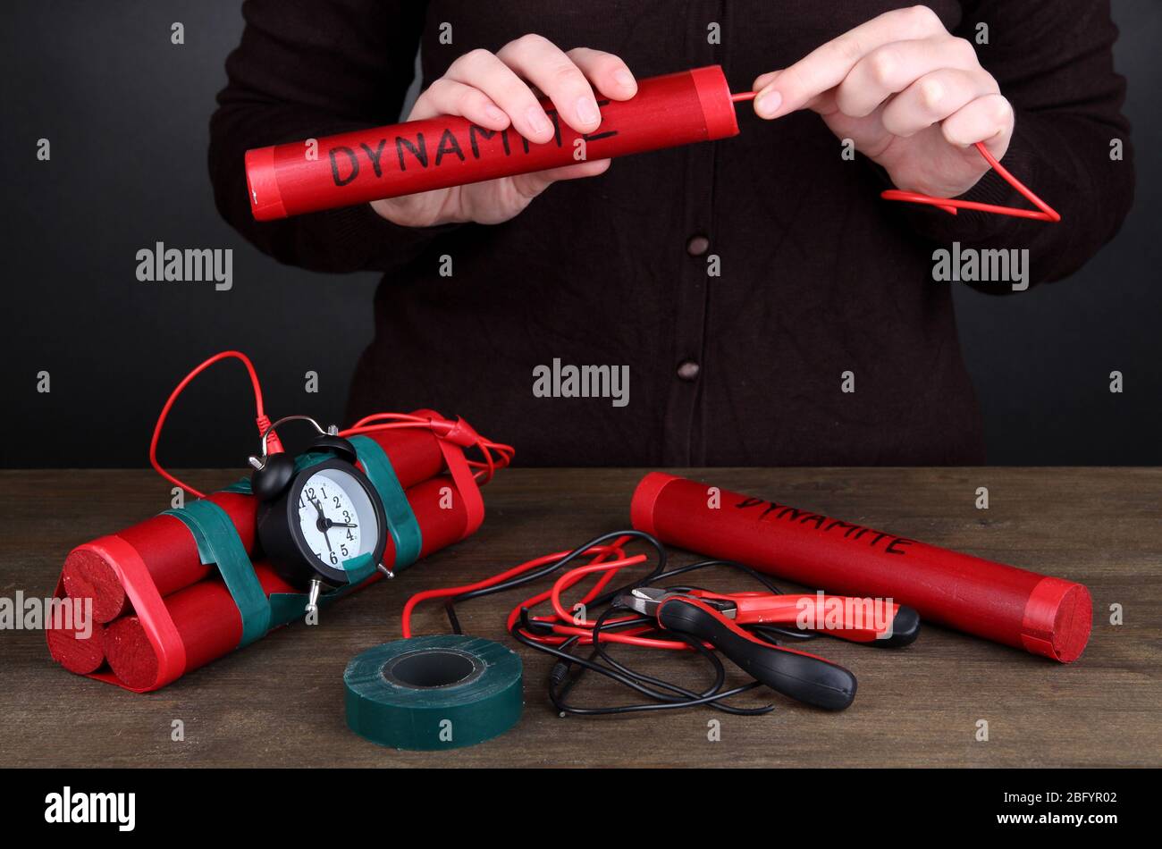 Human makes timebomb on wooden table on black background Stock Photo ...