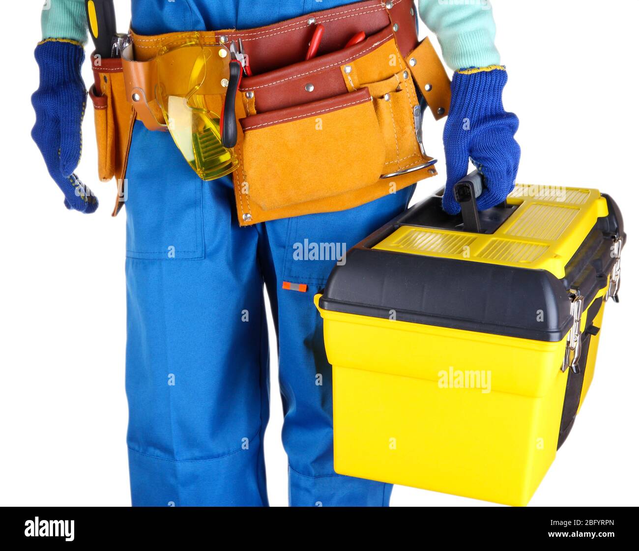 Male builder in blue overalls with yellow suitcase isolated on white ...