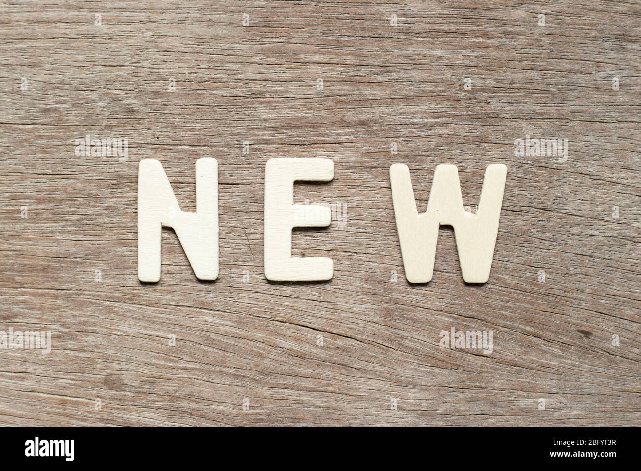 Alphabet letter in word new on wood background Stock Photo - Alamy