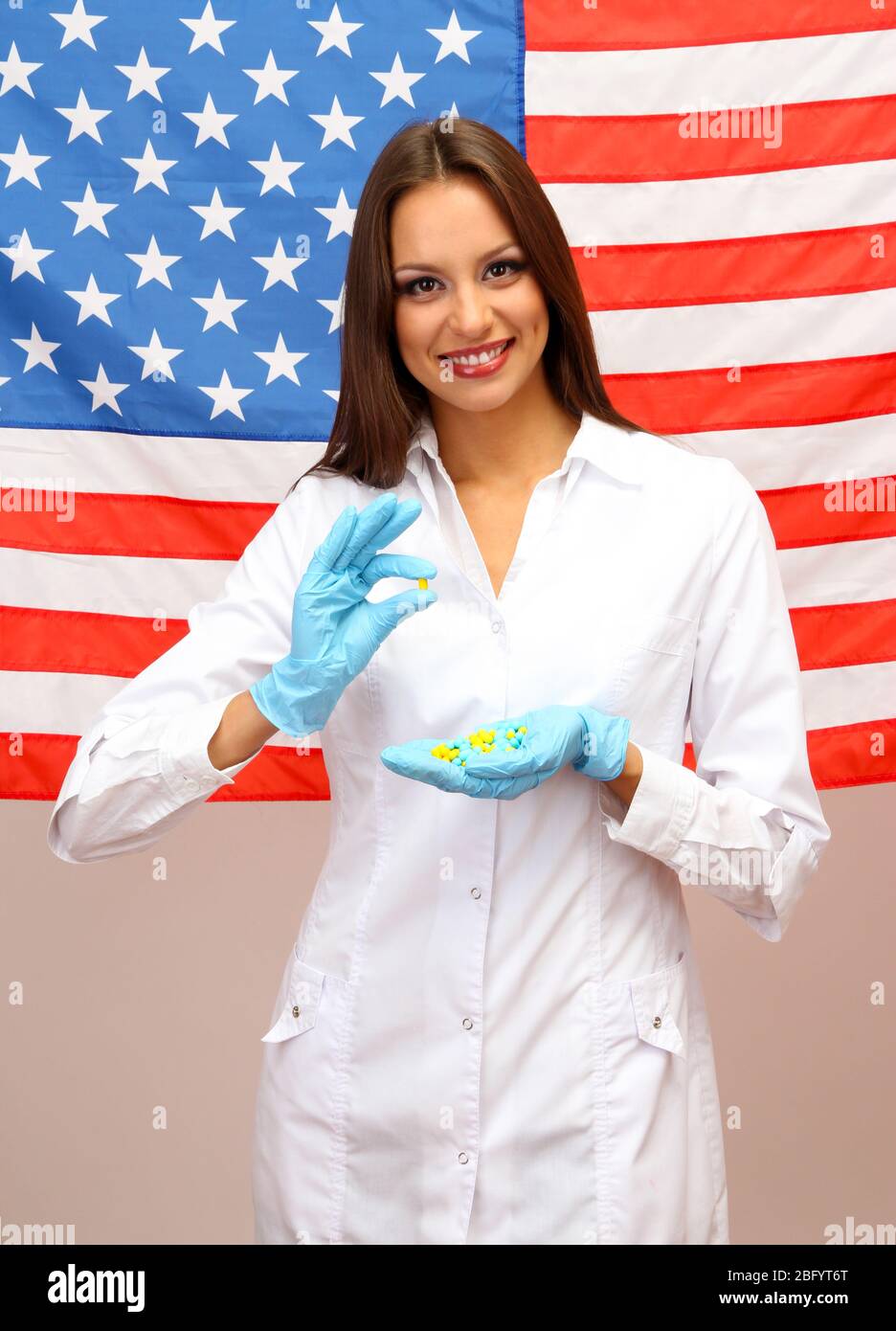 Portrait of female doctor or scientist showing and analyzing pills over ...