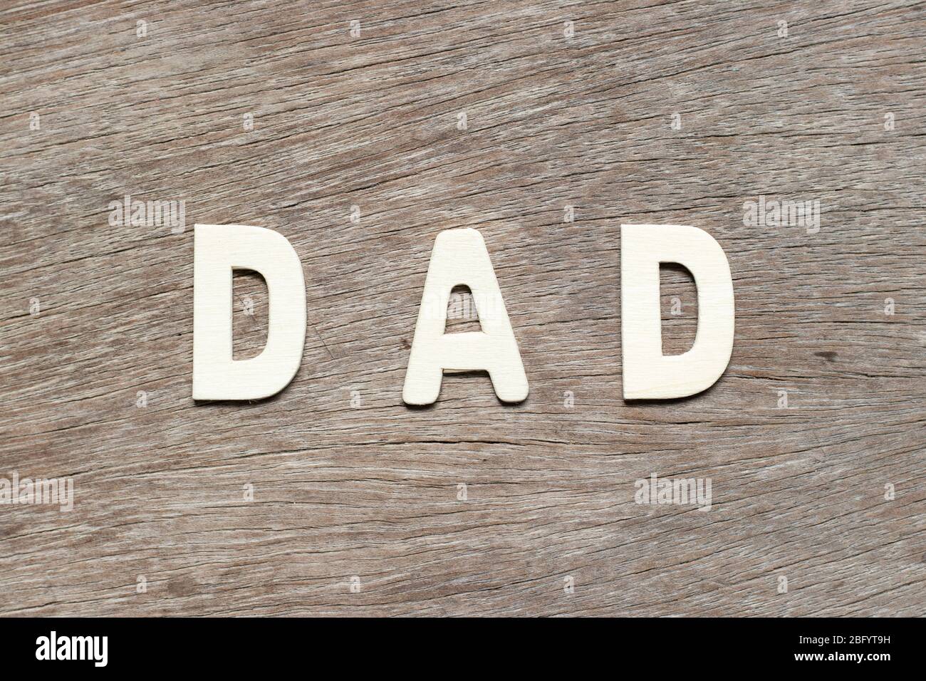 Alphabet letter in word dad on wood background Stock Photo - Alamy