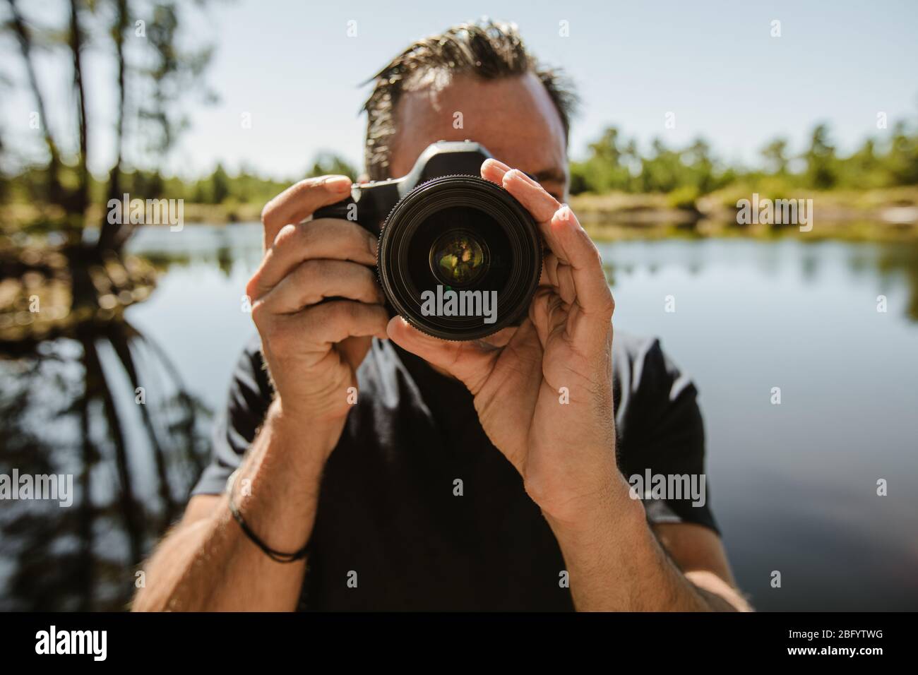 Mature man taking photographs with a dslr camera. Male photographer ...