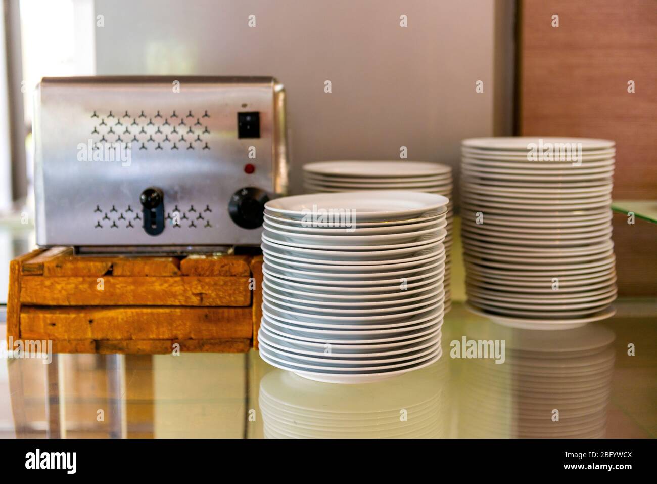 Stack of plates for the buffet on the table Stock Photo - Alamy