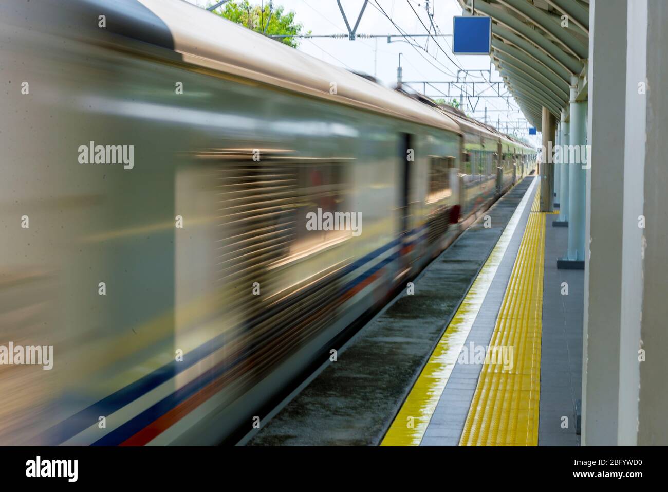 Fast train pass through the station with motion blur Stock Photo - Alamy