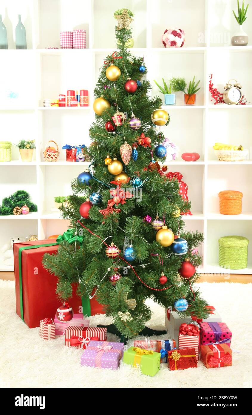 Decorated Christmas tree on home interior background Stock Photo - Alamy