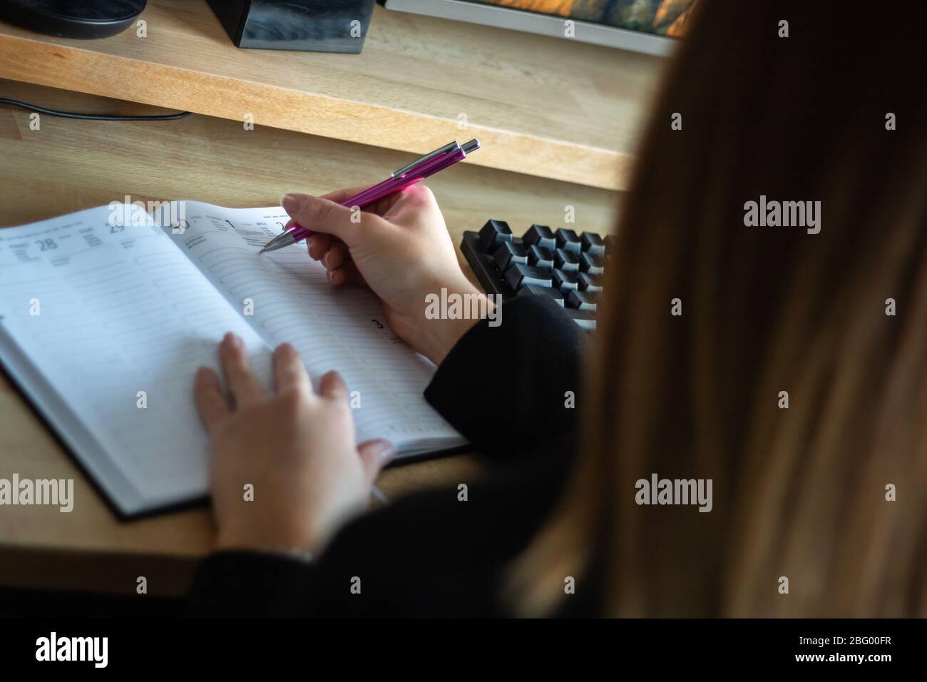 young woman writing to notebook Stock Photo - Alamy