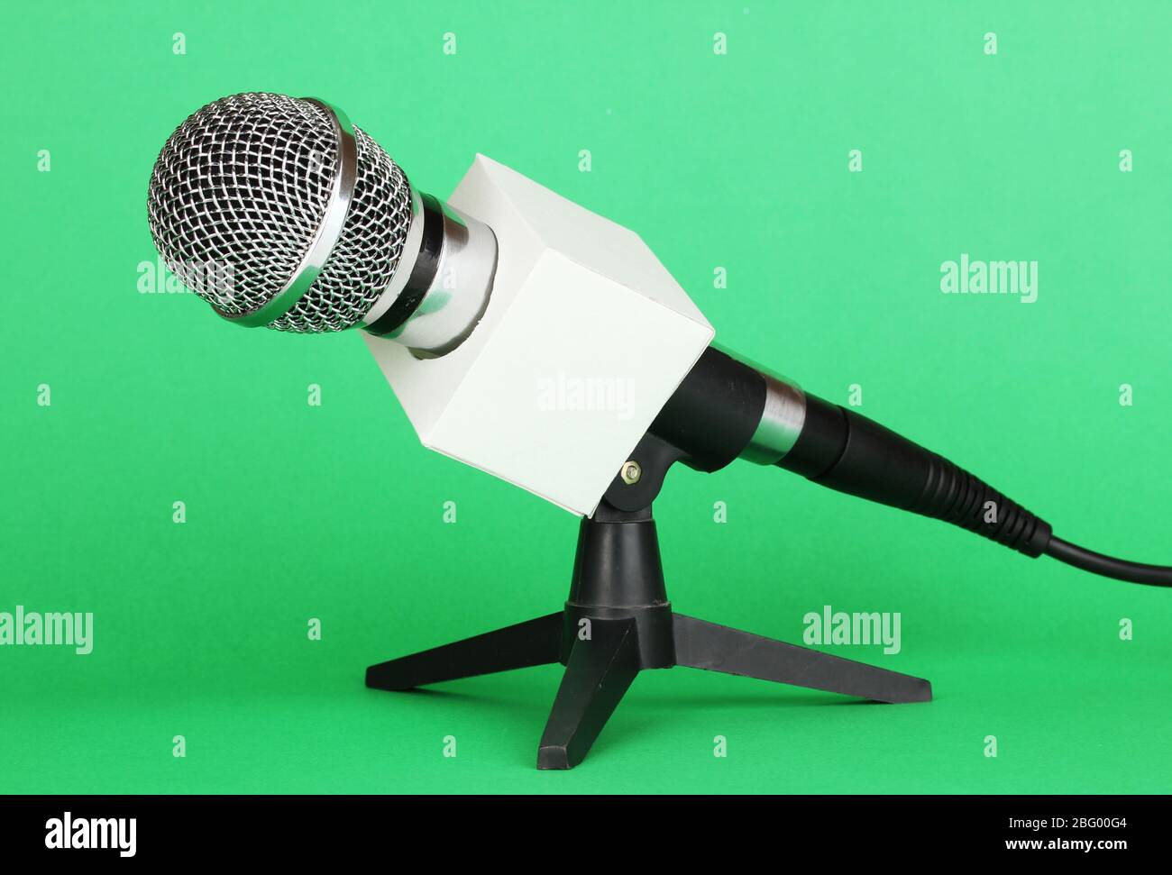 Microphone on stand on green background Stock Photo - Alamy