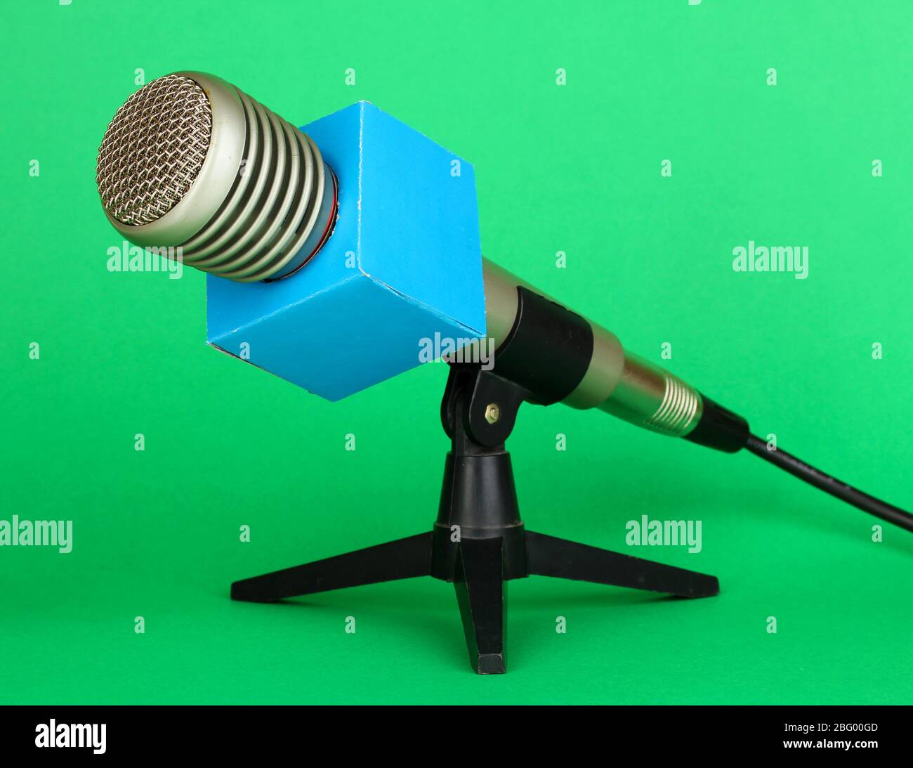 Microphone on stand on green background Stock Photo - Alamy